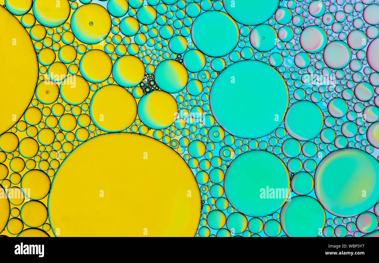 Multi-coloured bubble patterns formed by oil floating on water Stock ...