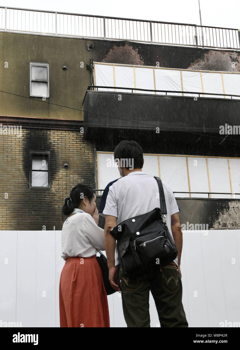 People visit the arson attack-hit studio of Kyoto Animation Co. in ...