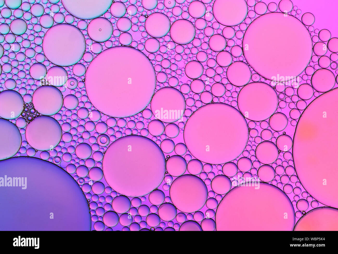Multi-coloured bubble patterns formed by oil floating on water Stock ...