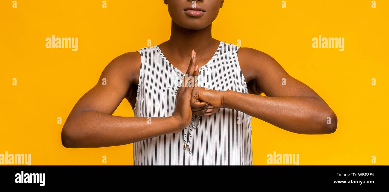 African american young girl showing lock sign Stock Photo - Alamy
