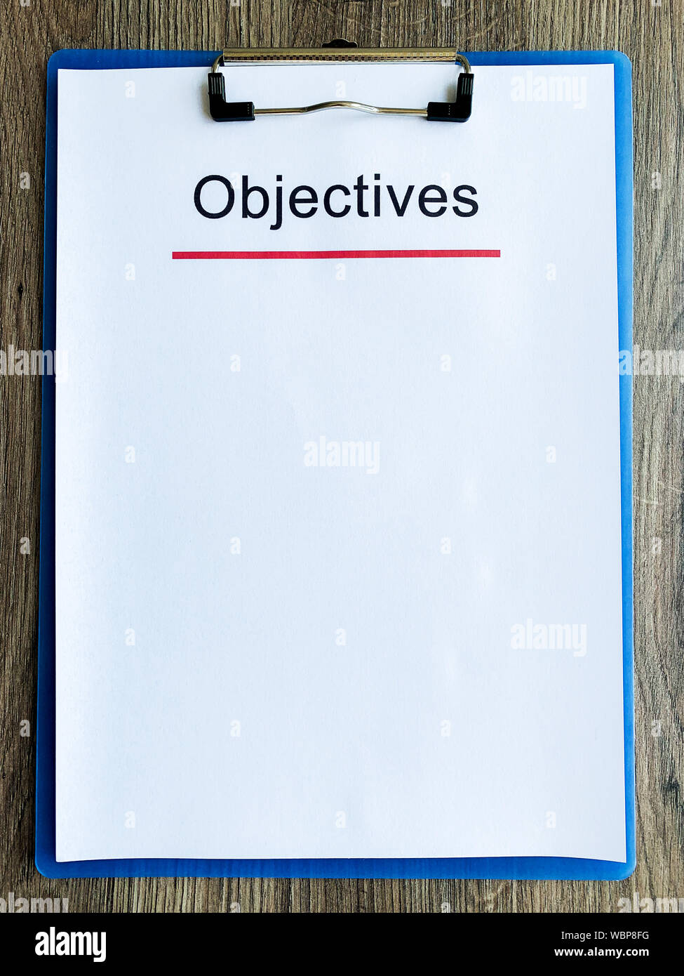 Paper with text objective on wood table Stock Photo - Alamy
