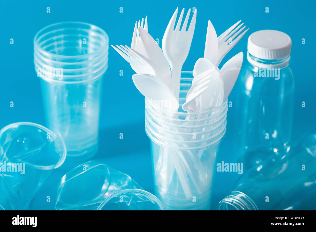 single use plastic cups, forks, spoons. concept of recycling plastic ...