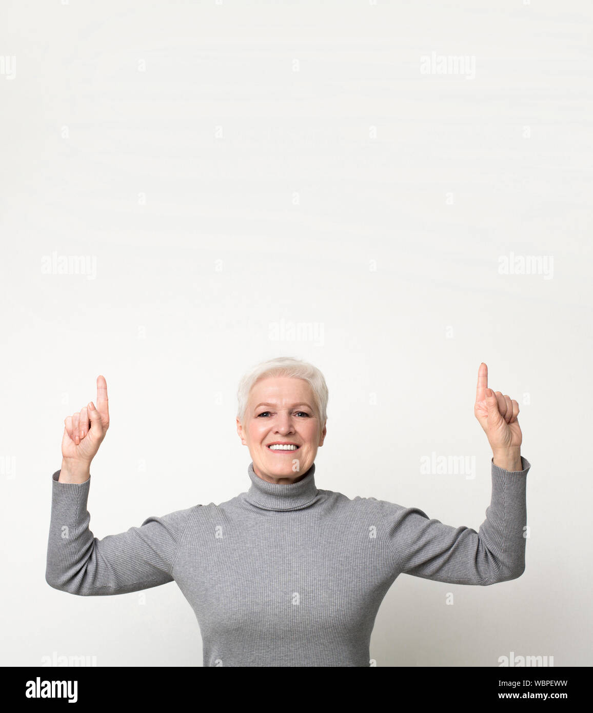 Woman pointing upwards hi-res stock photography and images - Alamy