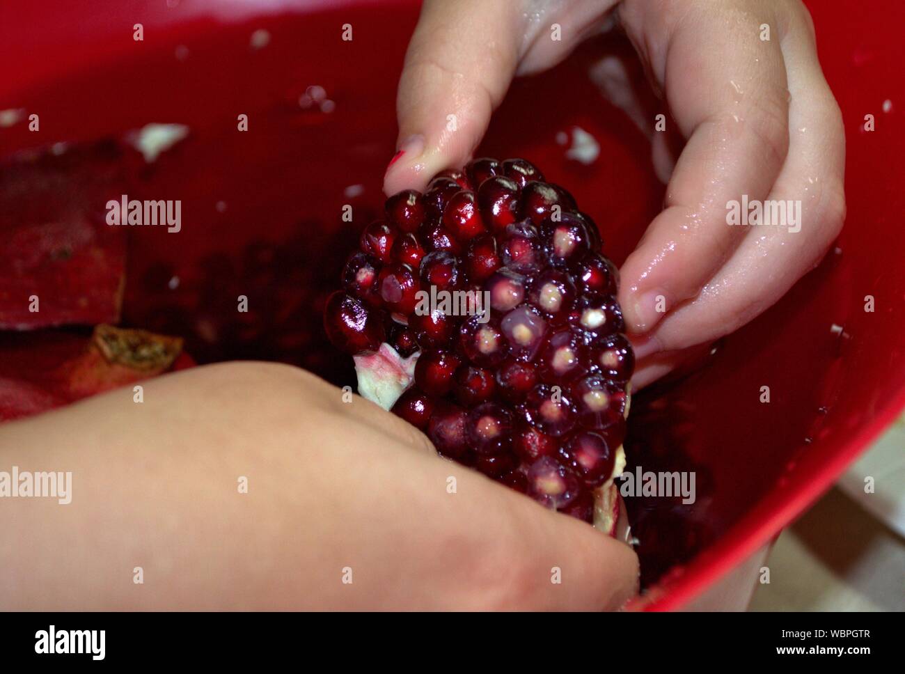 Hand holding pomegranate hi-res stock photography and images - Alamy