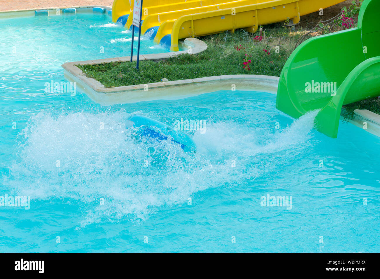 Colourful plastic slides in aquapark in the sunset. sliders, water park ...