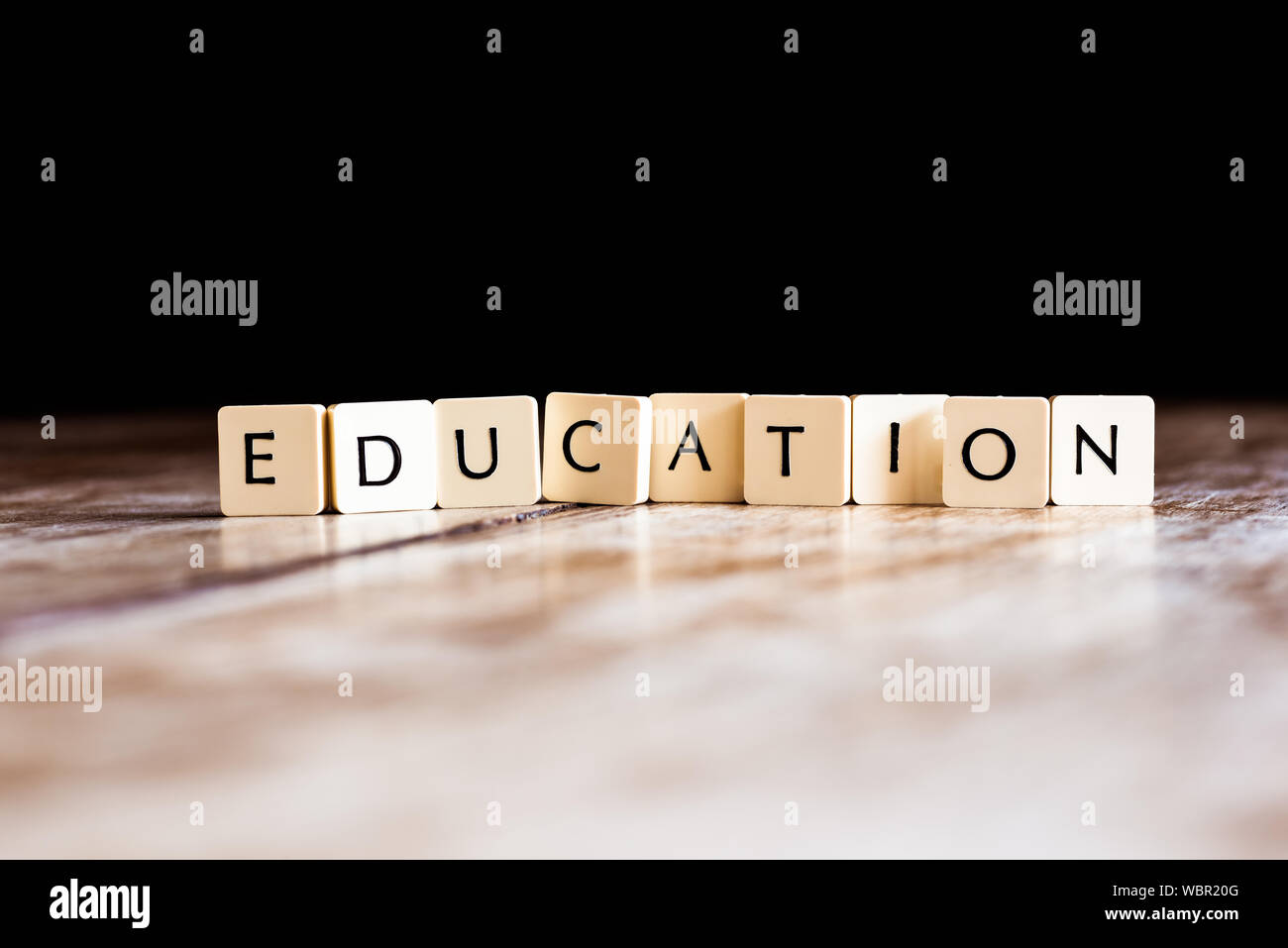 Education word made of tiles on dark wooden background Stock Photo - Alamy