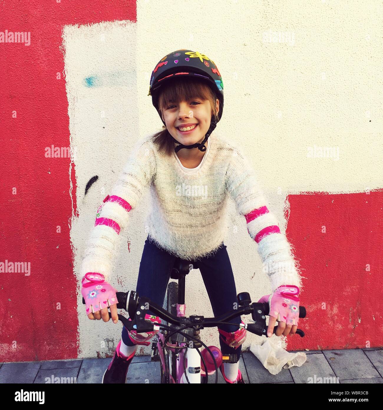 Portrait Of Smiling Girl Riding Bicycle Stock Photo - Alamy