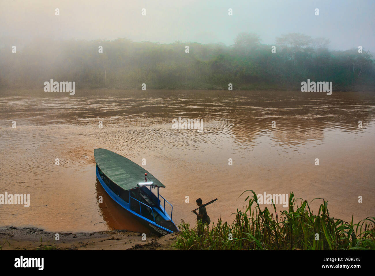 Longtail boat on the Tambopata River, Tambopata National Reserve ...