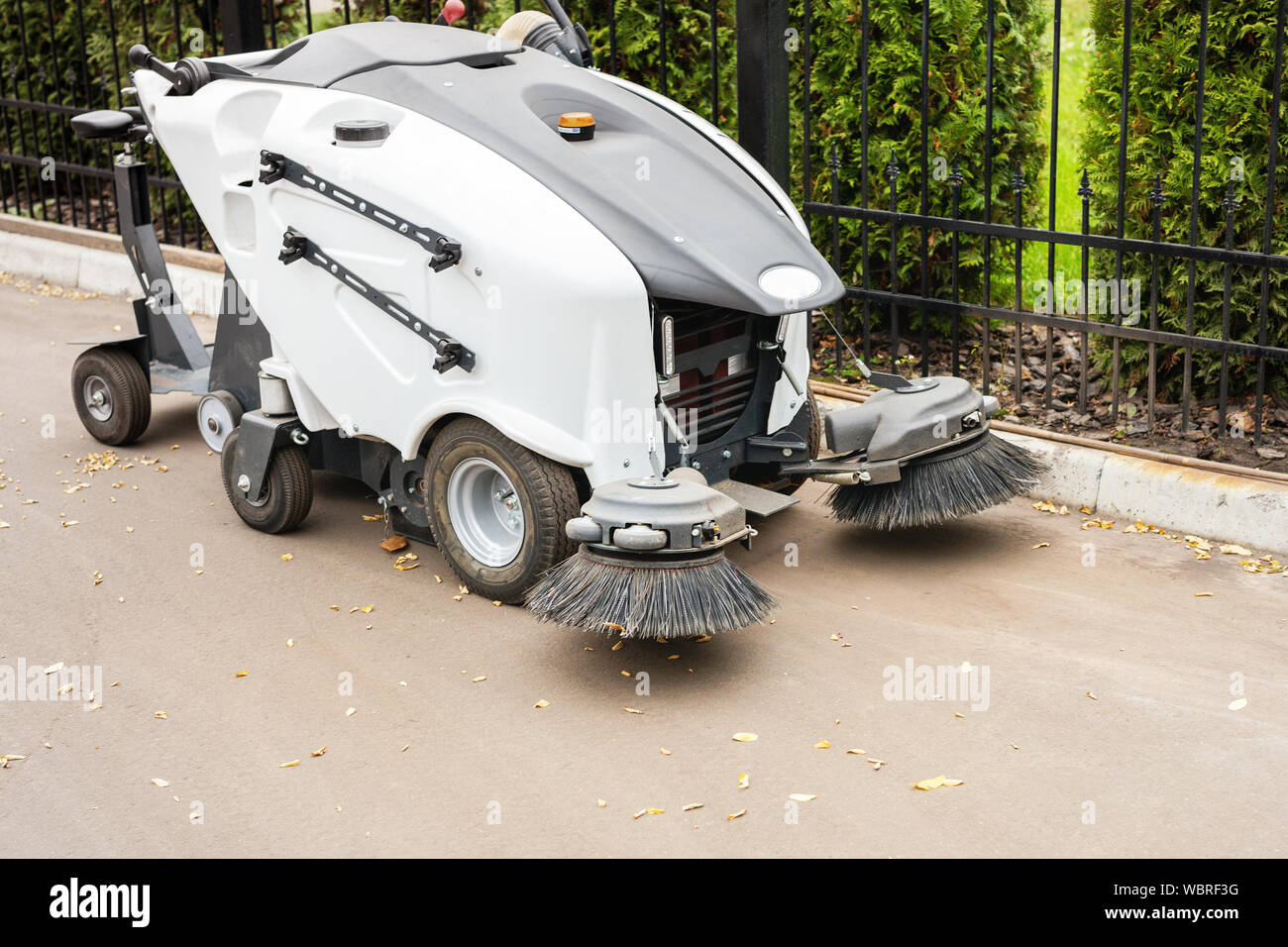 Small sweeper machine standing at parking storage after cleaning city ...