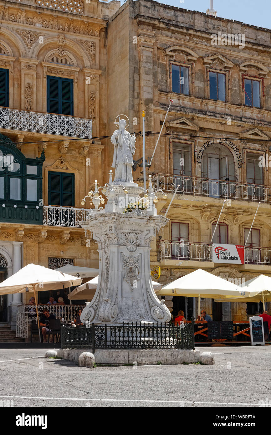 St. Lawrence statue; 16 century; large pedestal; flowers, lights ...