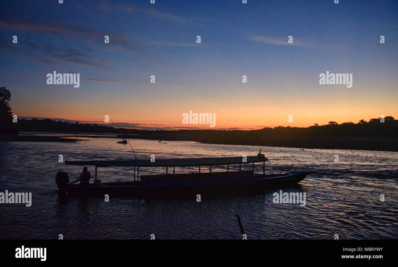 Longtail boat on the Tambopata River, Tambopata National Reserve ...