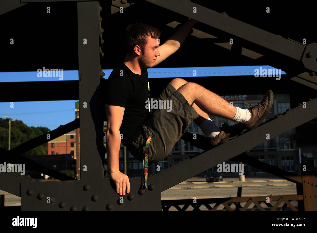 Portrait of young man sitting on railing hi-res stock photography and ...