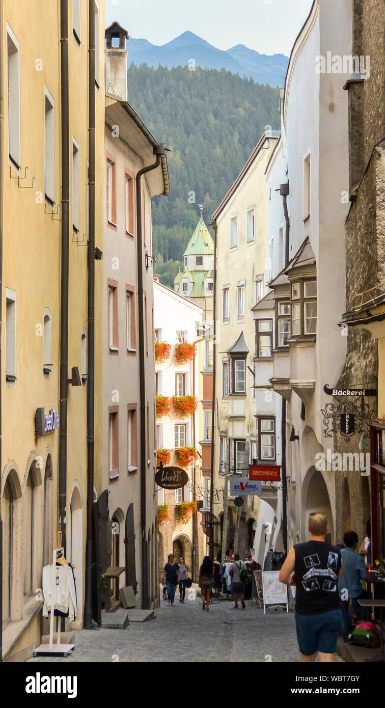A narrow shop lined street in the ancient town of Hall in Tirol ...