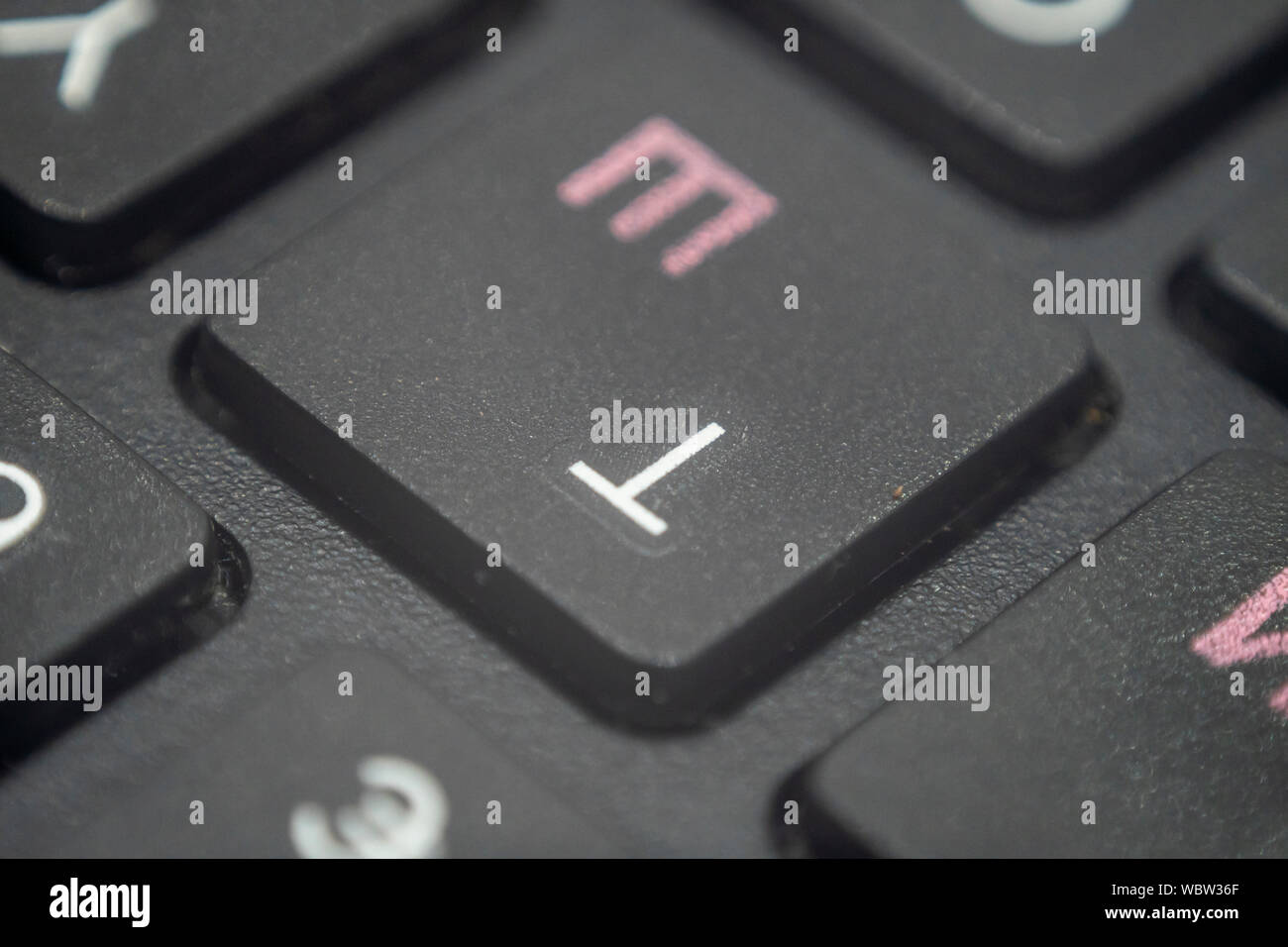 Extreme macro of the letter T on a laptop keyboard Stock Photo - Alamy