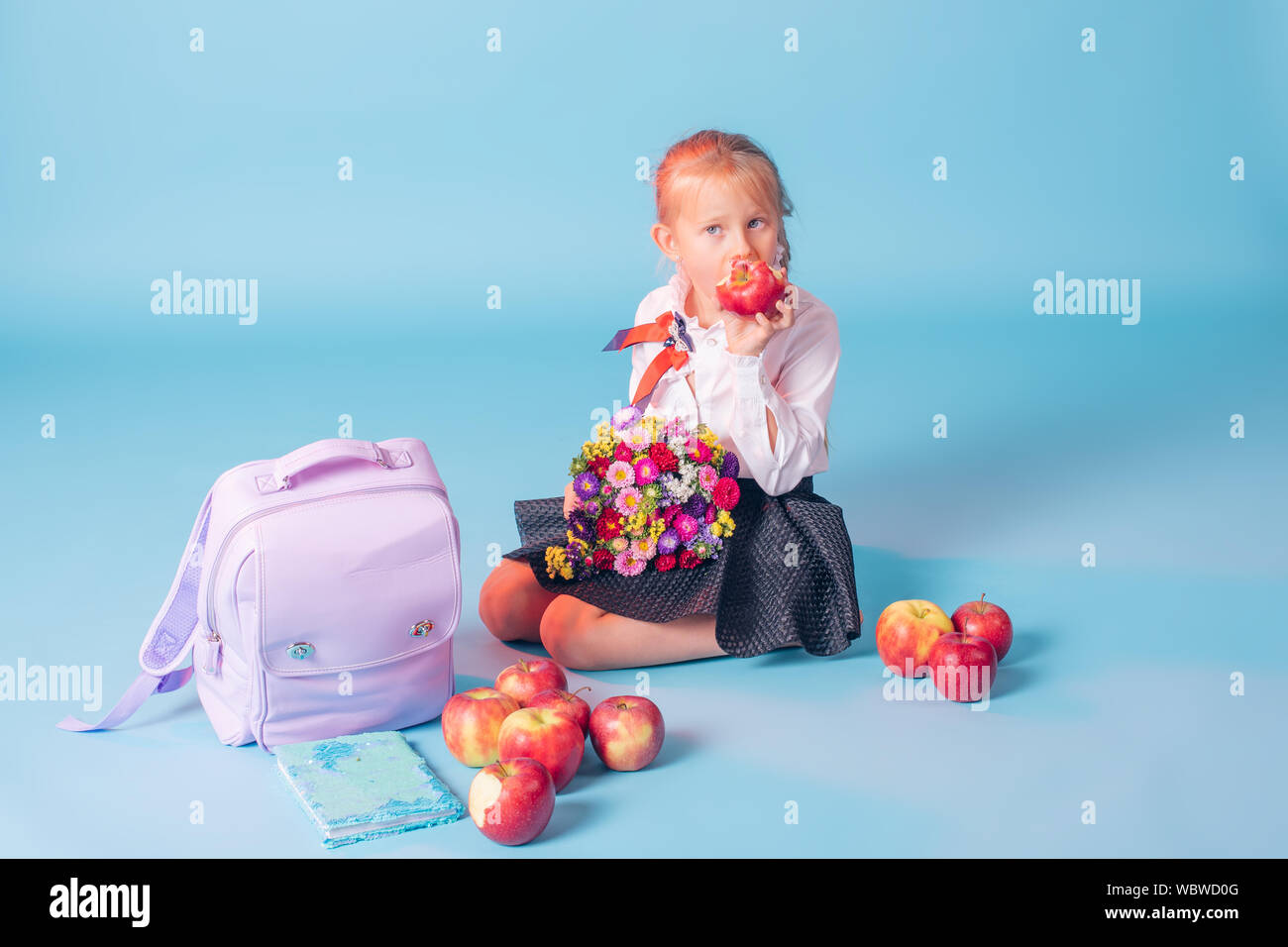 Portrait of beautiful young first-grader. First-grader girl in the ...