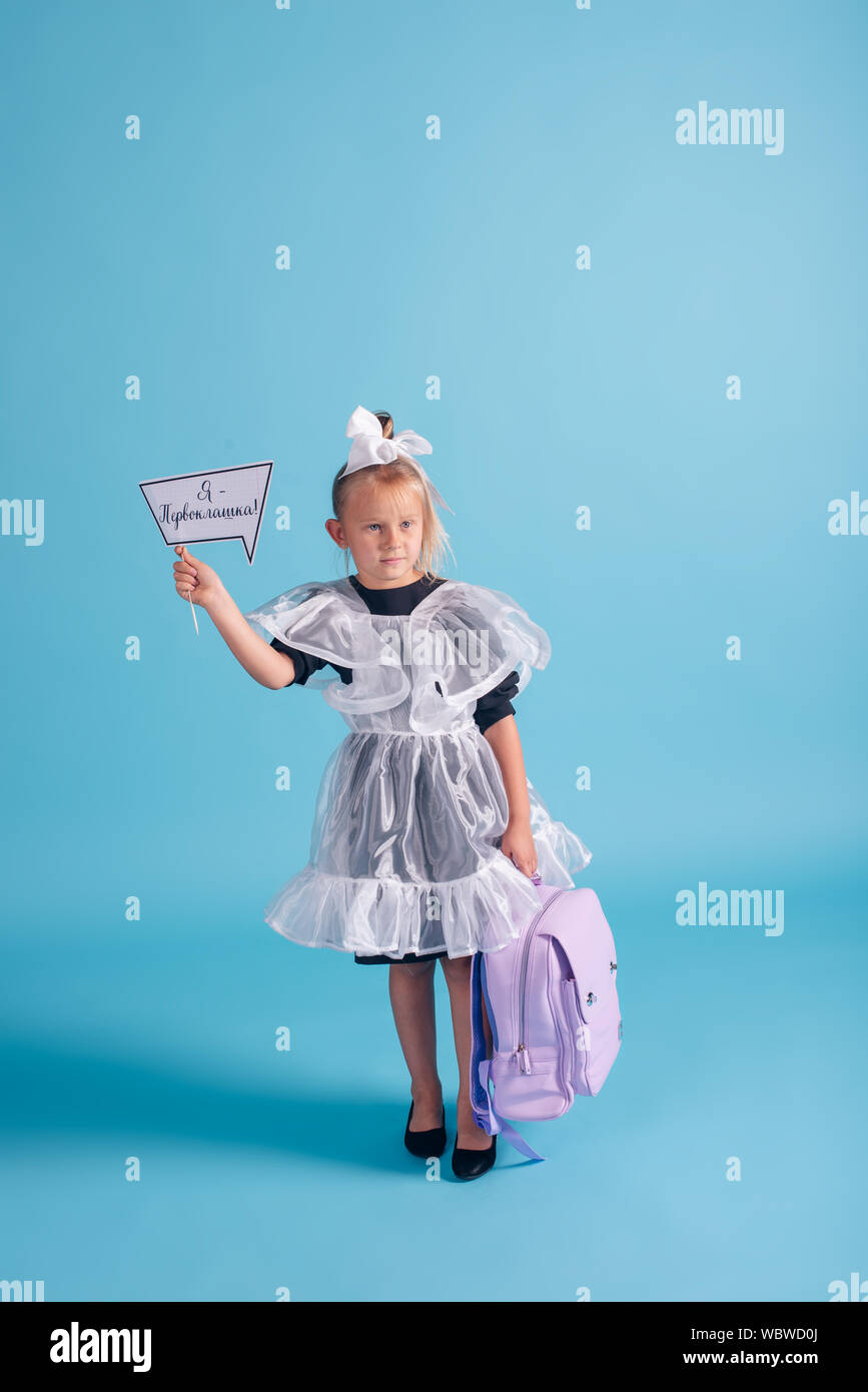 Portrait of beautiful young first-grader. First-grader girl in the ...
