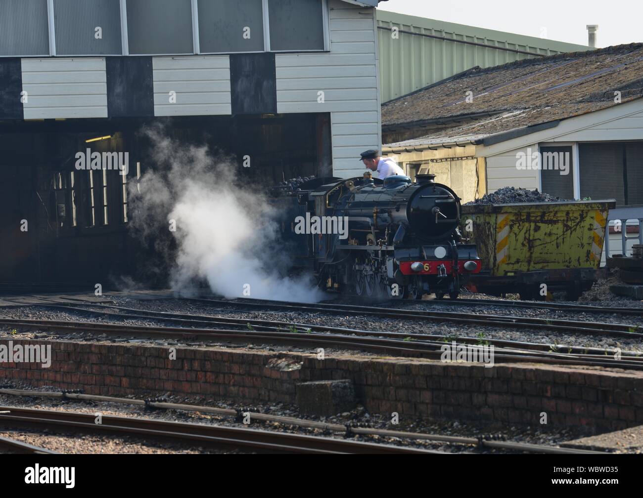 A steam train outside an engine shed Stock Photo - Alamy
