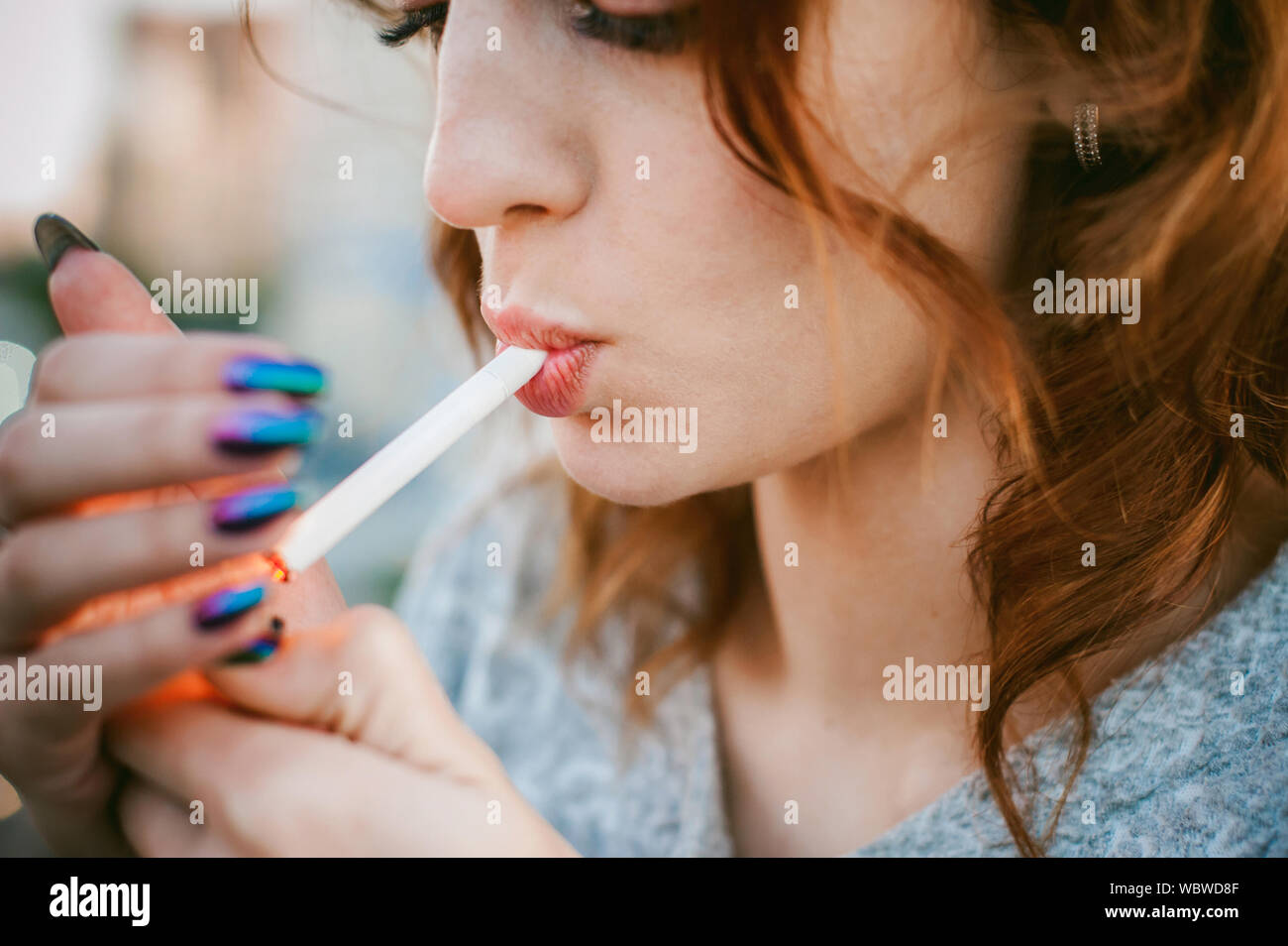 Close up woman lighting cigarette hi-res stock photography and images - Alamy