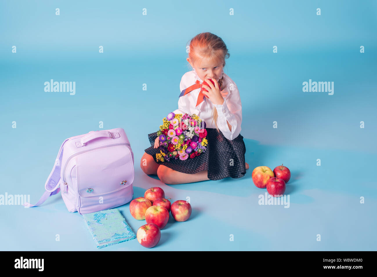 Portrait of beautiful young first-grader. First-grader girl in the ...