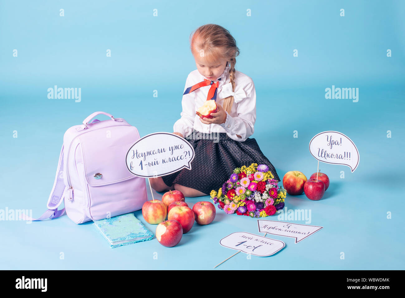 Portrait of beautiful young first-grader. First-grader girl in the ...