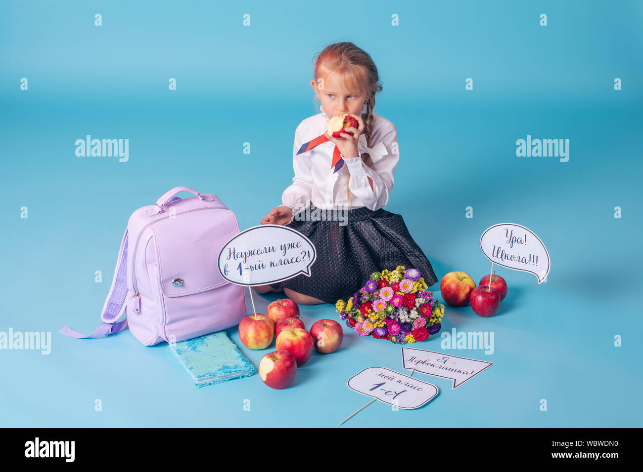 Portrait of beautiful young first-grader. First-grader girl in the ...