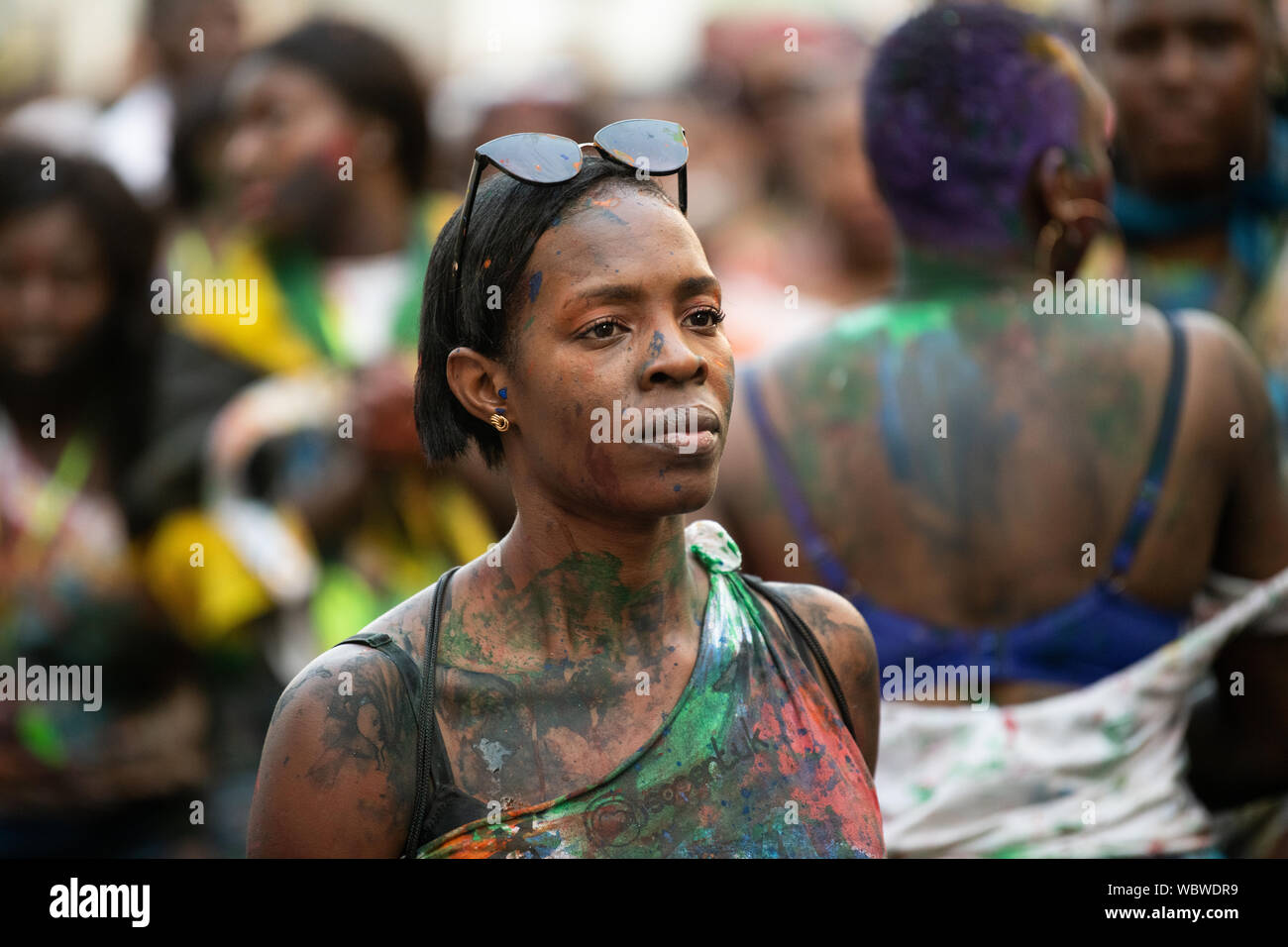 A black woman standing In the middle of a crowd at Notting Hill ...