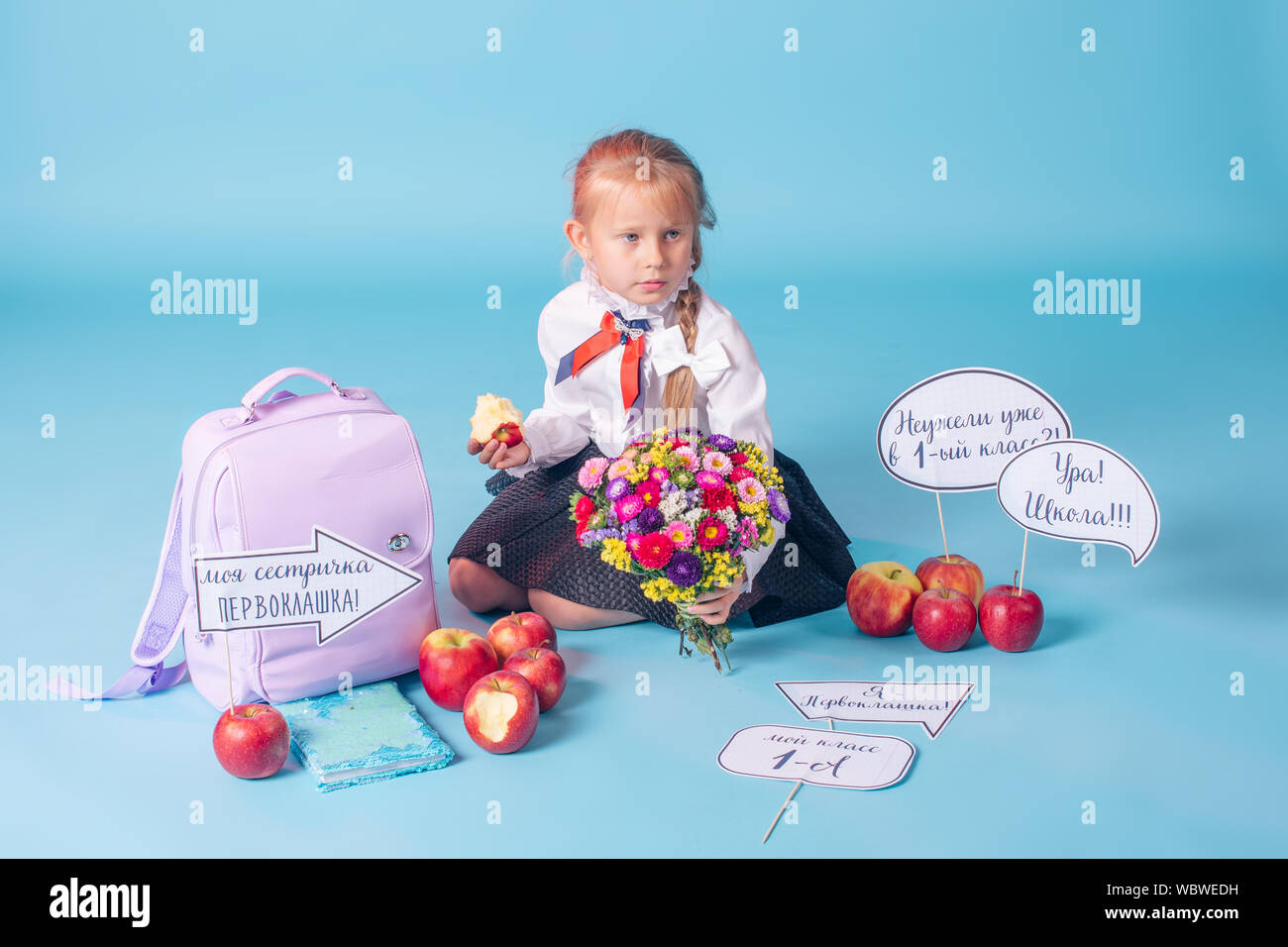 Portrait of beautiful young first-grader. First-grader girl in the ...