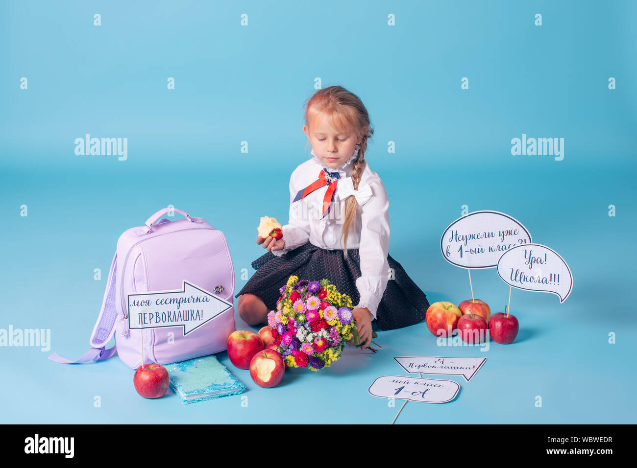 Portrait of beautiful young first-grader. First-grader girl in the ...
