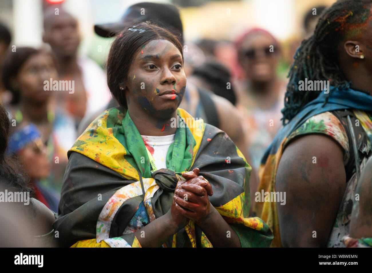 A black woman standing In the middle of a crowd at Notting Hill ...