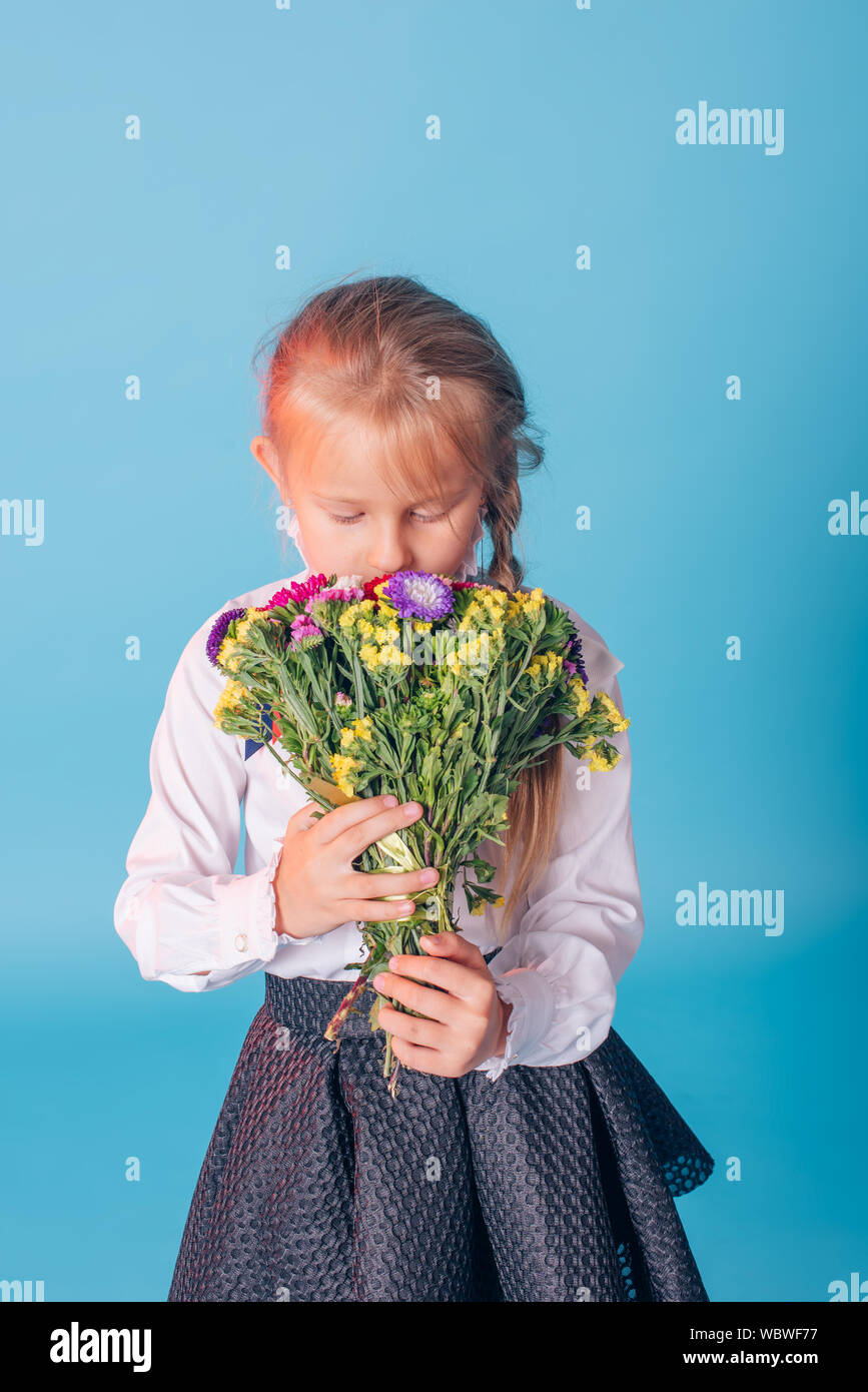 Portrait of beautiful young first-grader. First-grader girl in the ...