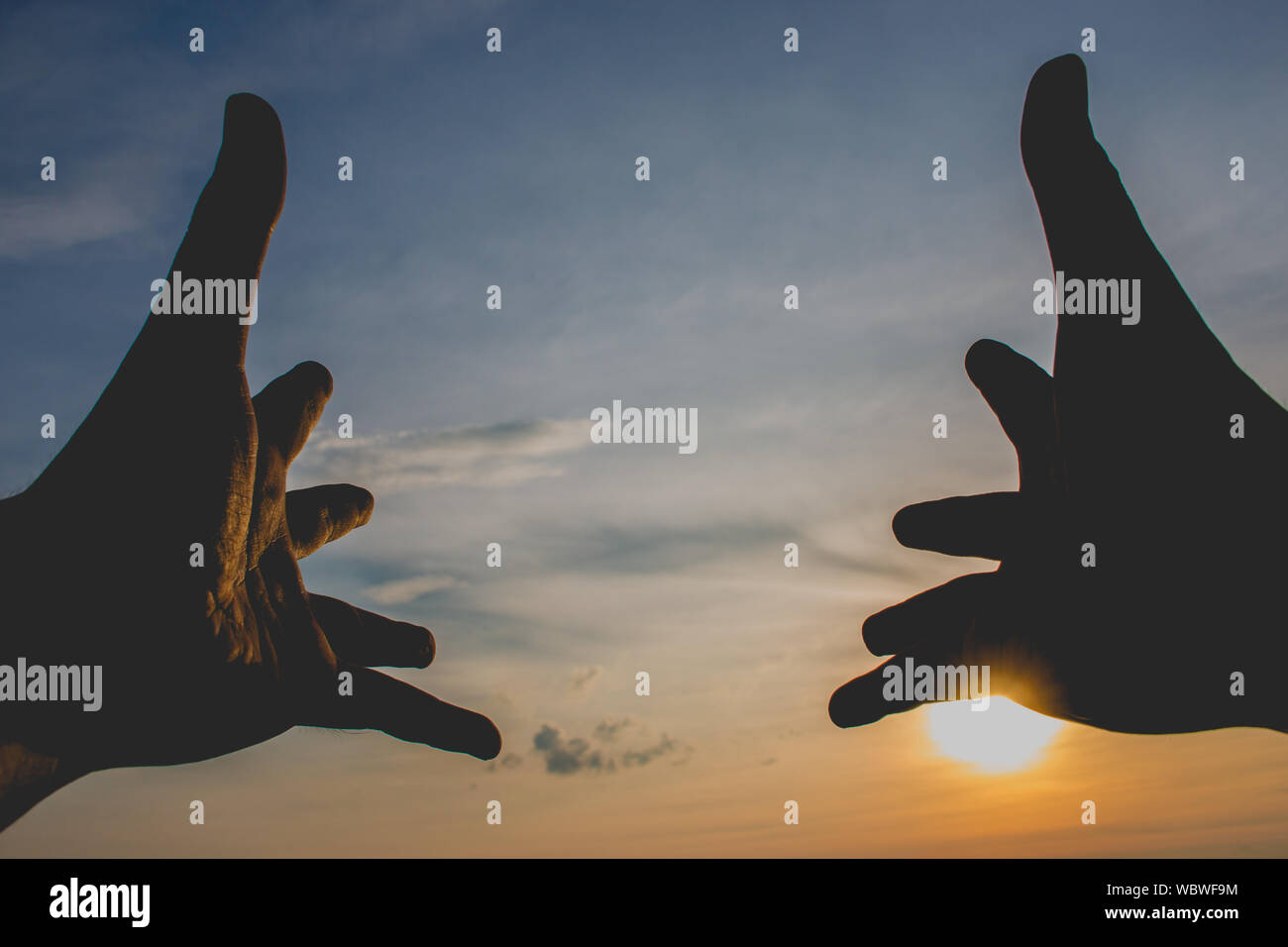 Hand reaching towards sunlight hi-res stock photography and images - Alamy