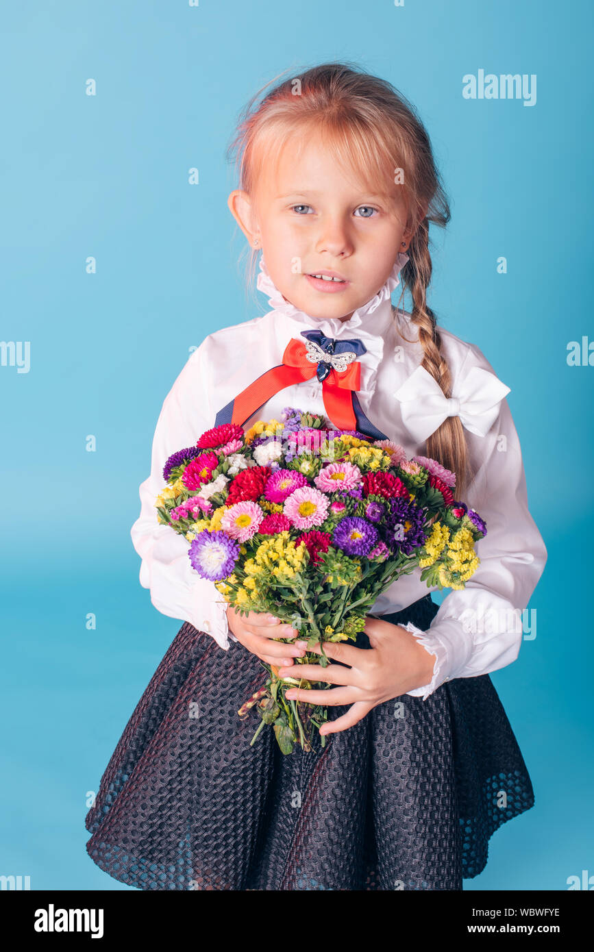 Portrait of beautiful young first-grader. First-grader girl in the ...