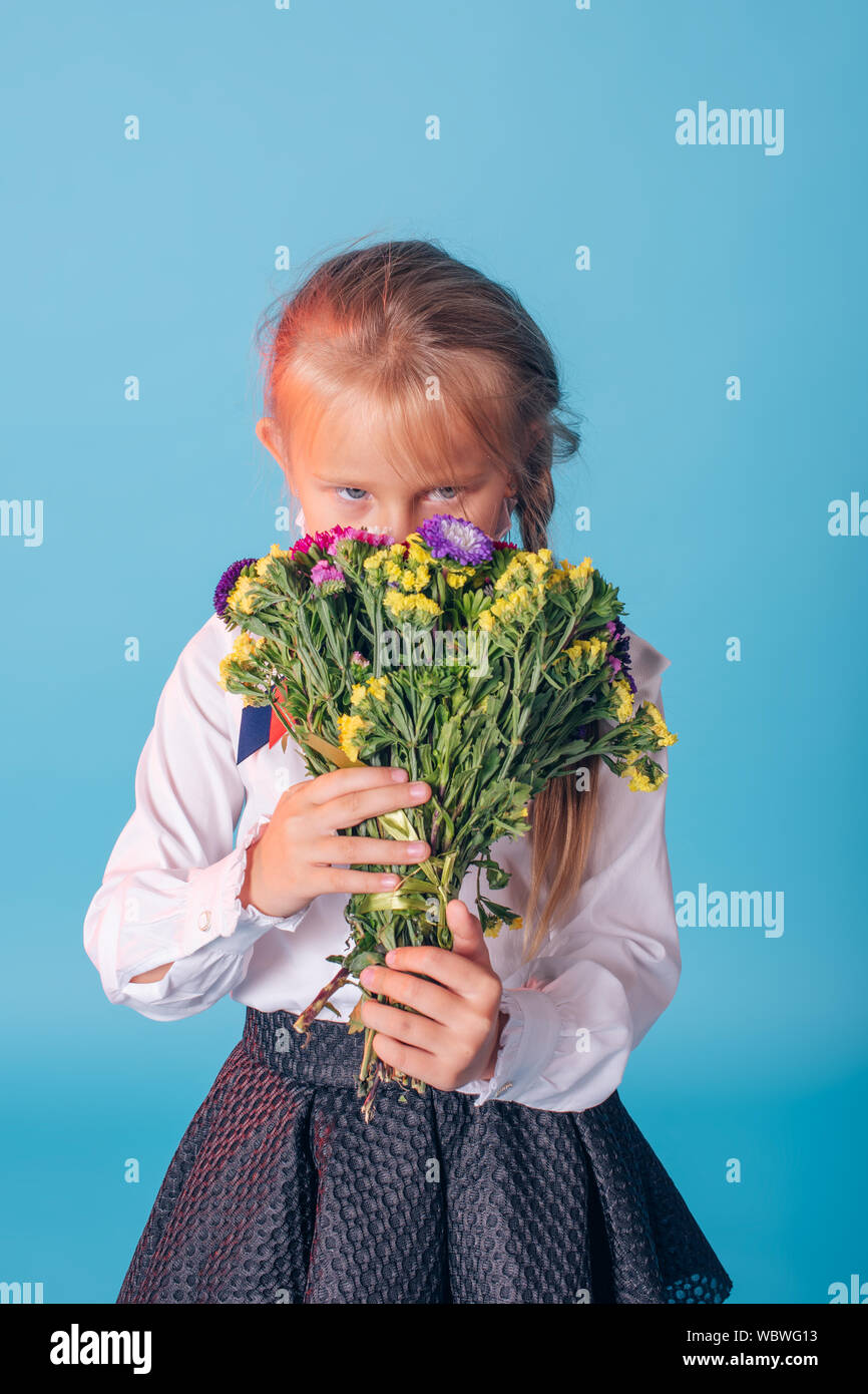 Portrait of beautiful young first-grader. First-grader girl in the ...