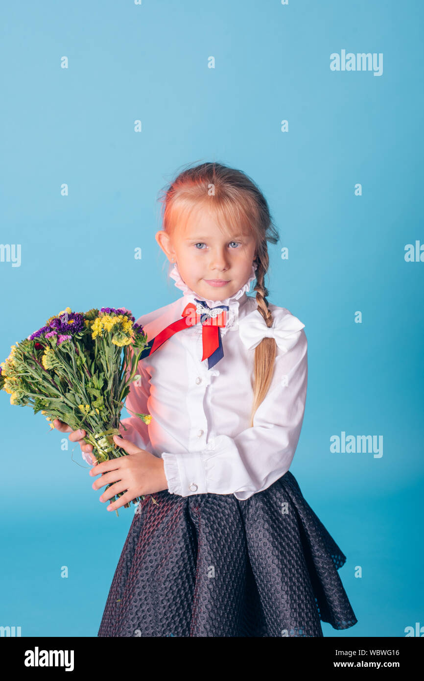 Portrait of beautiful young first-grader. First-grader girl in the ...