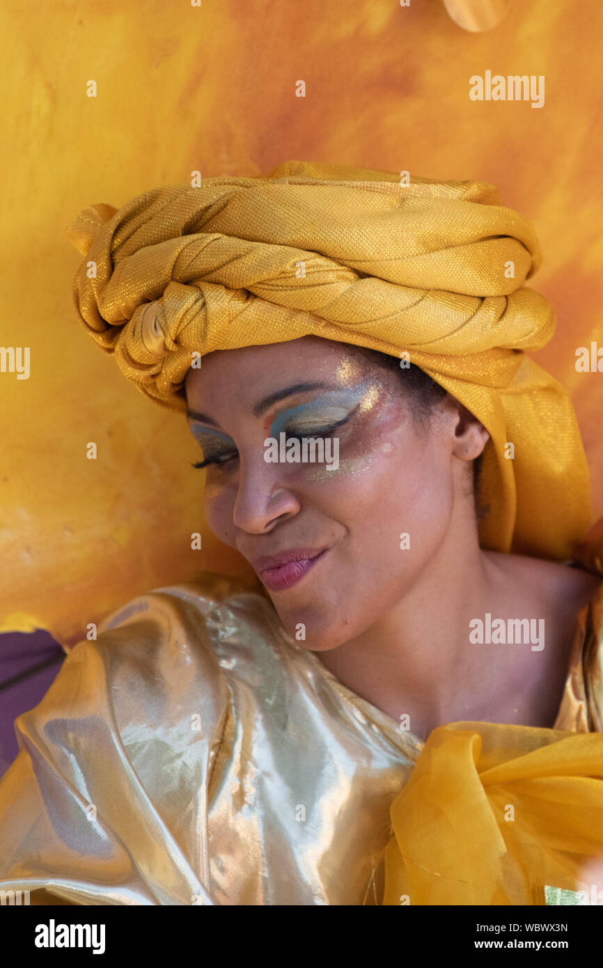 A woman in a yellow head scarf smiling at Notting Hill Carnival Stock ...