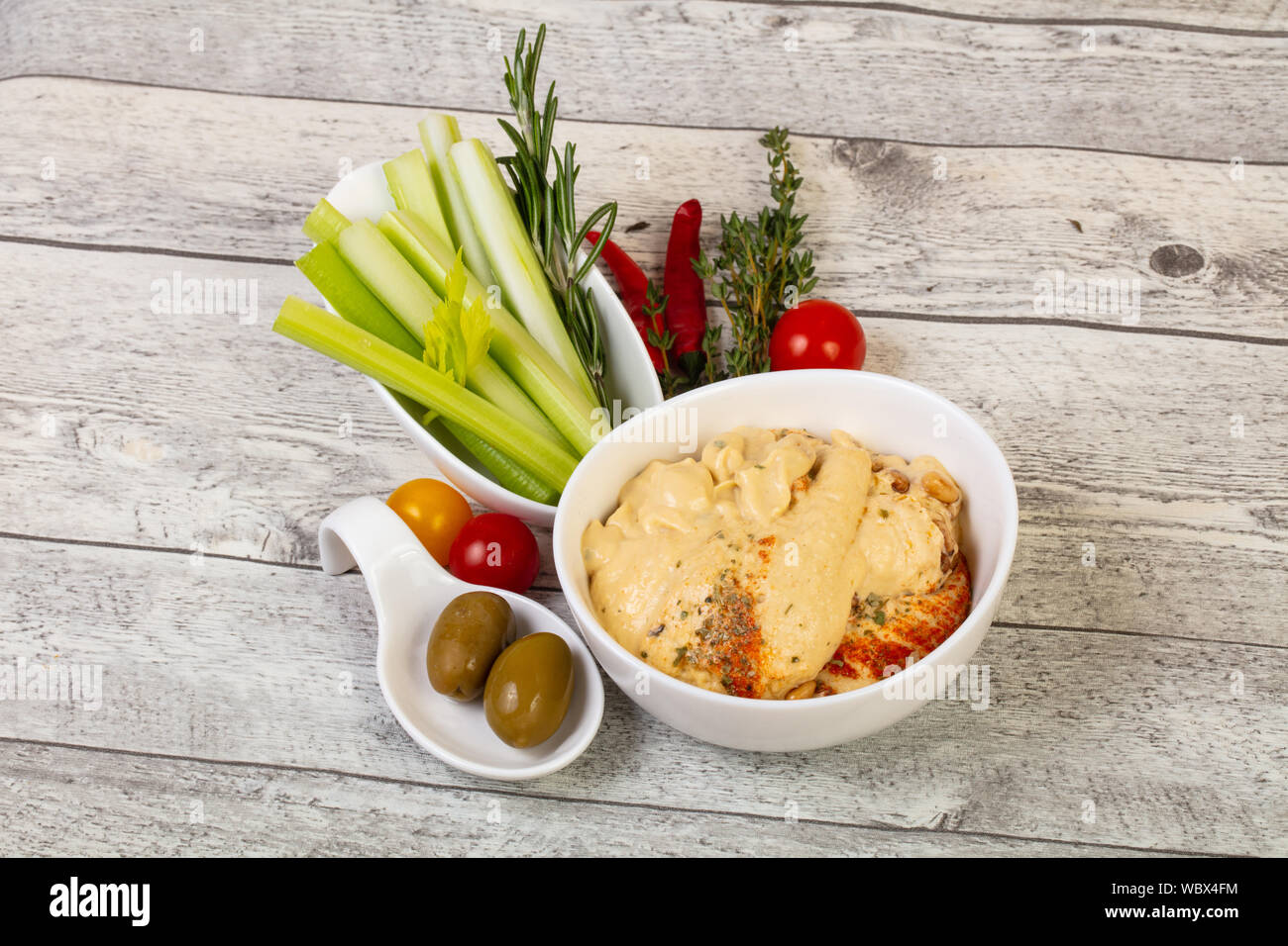Vegan cuisine - Humus with celery sticks Stock Photo - Alamy