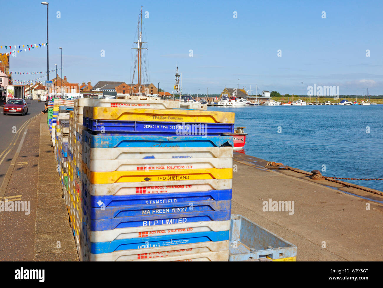 Fish boxes stacked on the quayside at the North Norfolk port of Wells ...