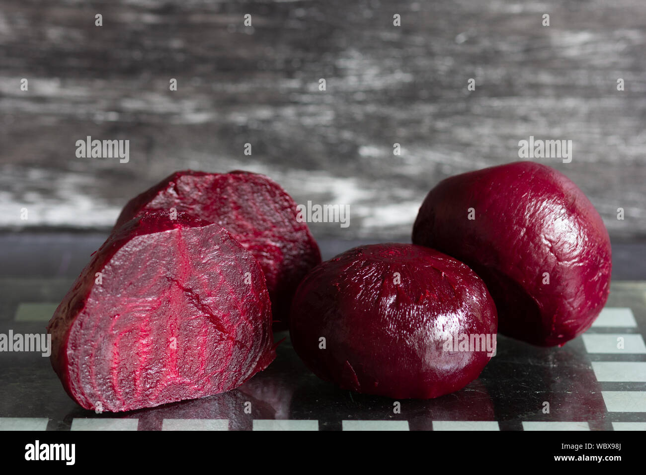 Roots of cooked peeled beet in on black background Stock Photo - Alamy