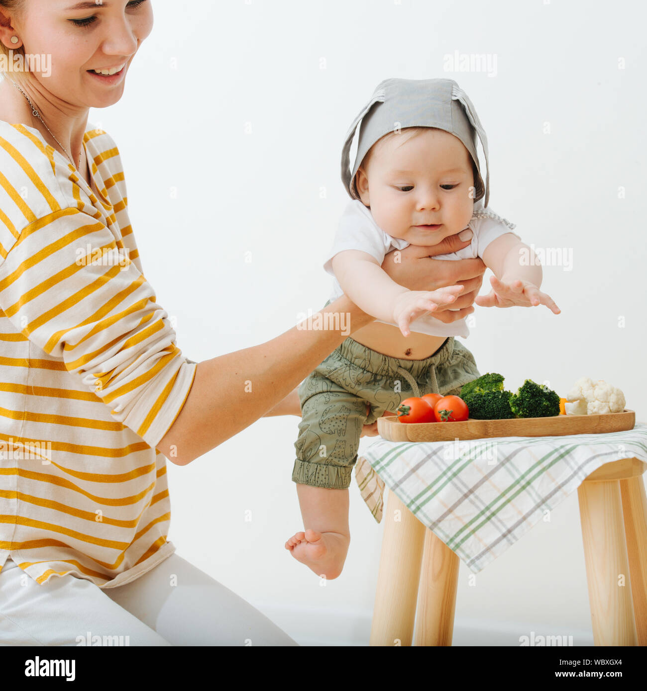 Active restless infant child is presented food Stock Photo - Alamy