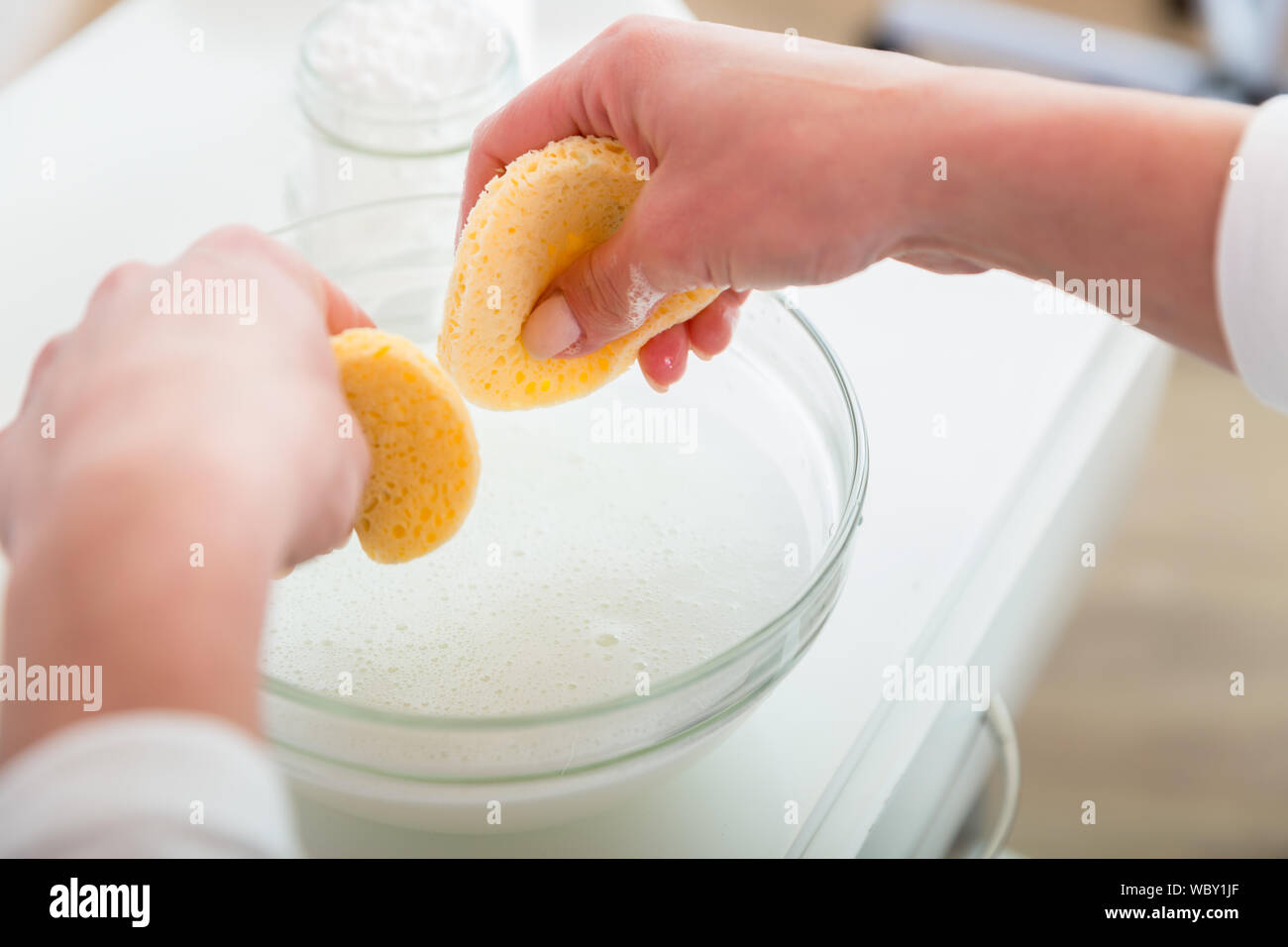 Cosmetologist hand cleaning sponge Stock Photo - Alamy