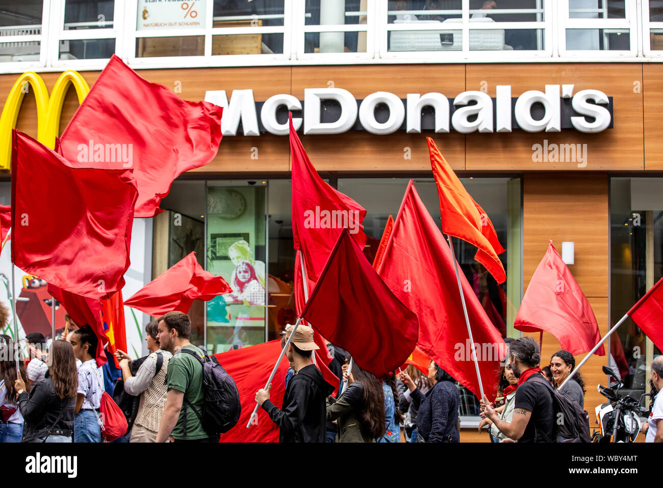 Demonstration of left-wing groups, red flags of communist parties ...