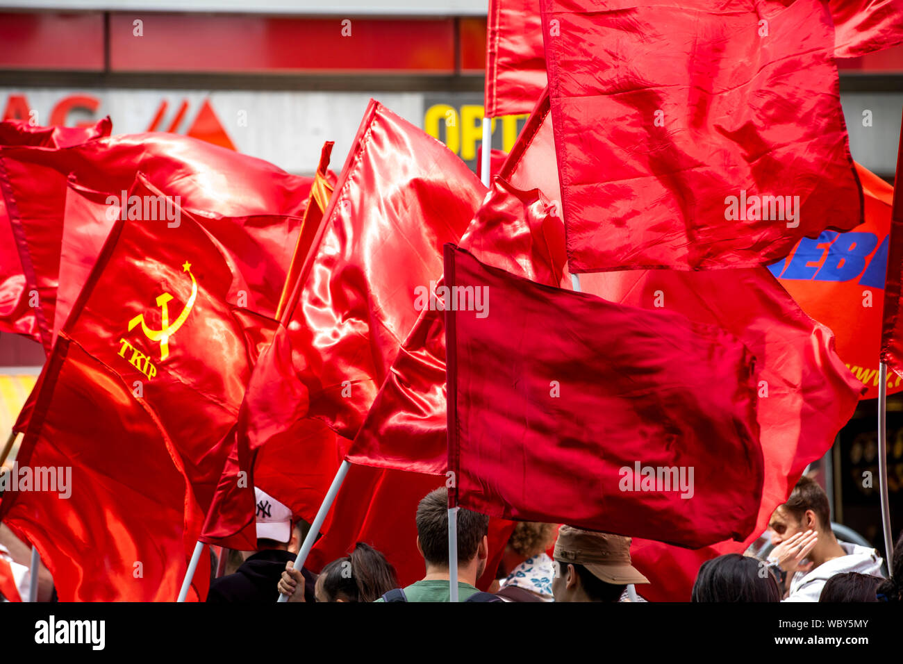 Demonstration of left-wing groups, red flags of communist parties ...