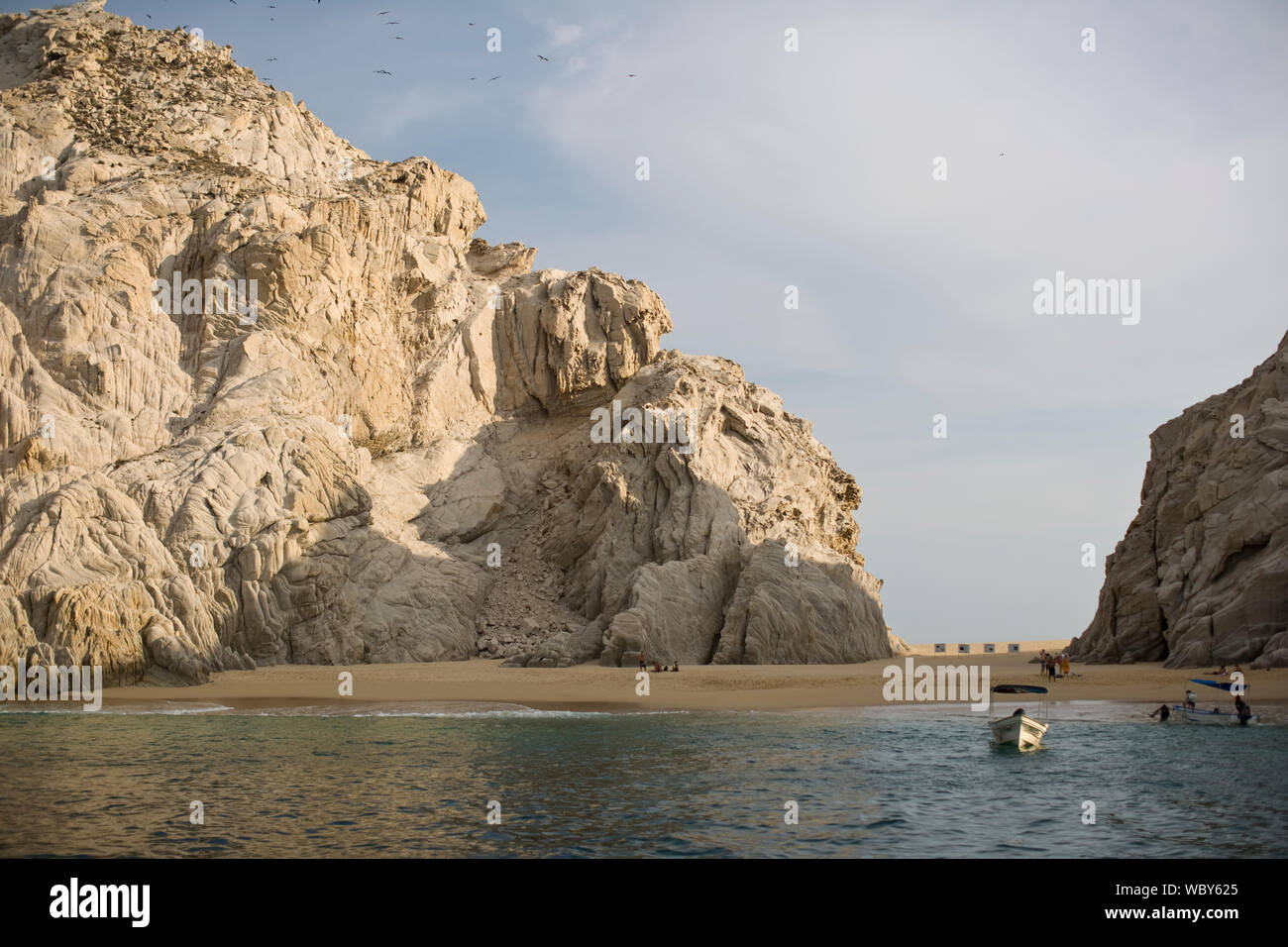 Sandy beach in between a rocky landscape Stock Photo - Alamy