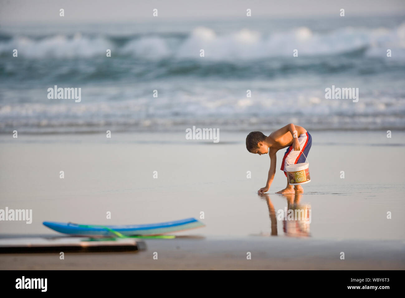Child picking something up hi-res stock photography and images - Alamy