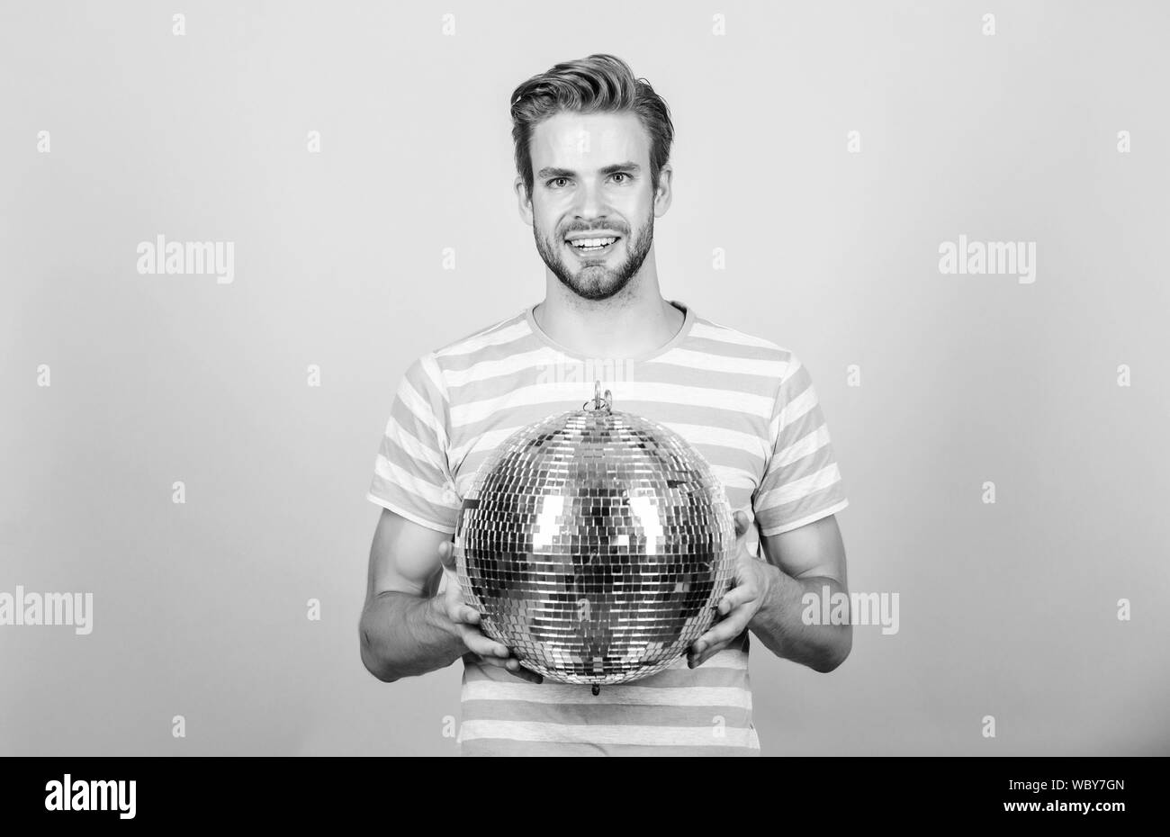 Guy inviting you at party. Thousand tiny mirrors reflecting lights ...