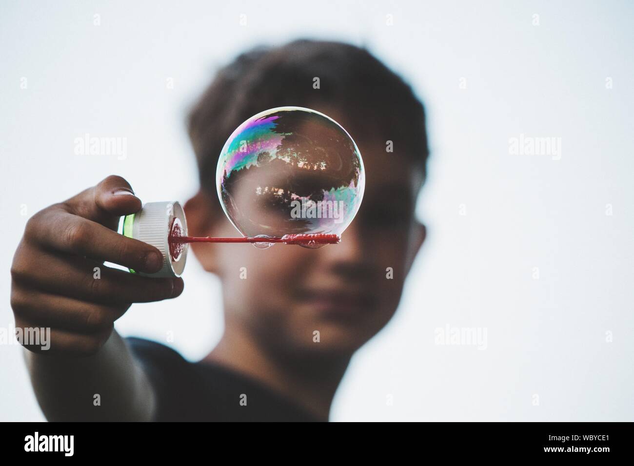 Hand holding bubble wand hi-res stock photography and images - Alamy