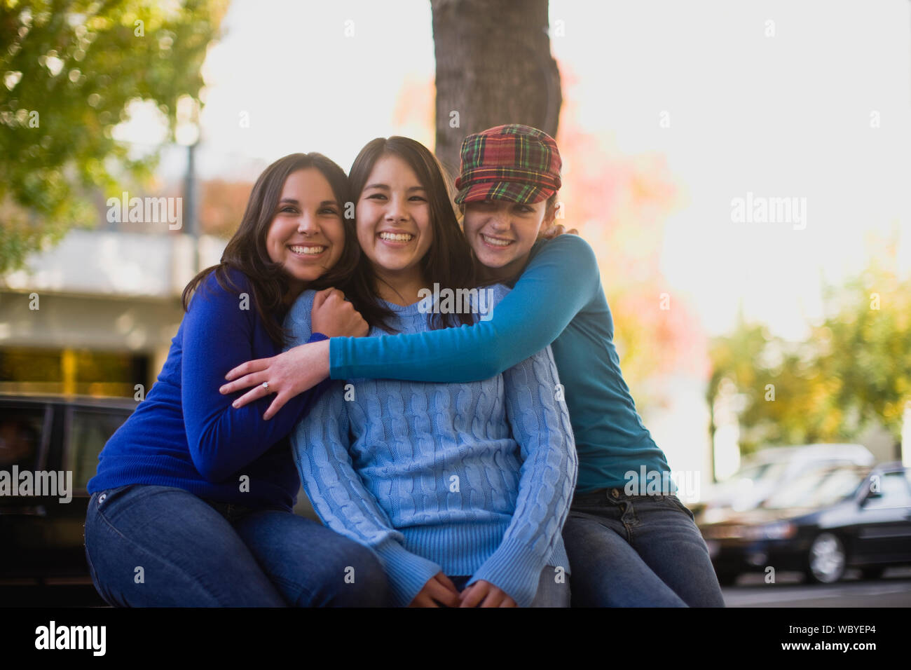 Girls hugging each other and smiling Stock Photo - Alamy