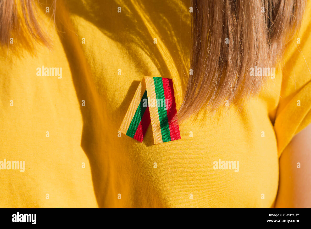 Small lithuanian flag ribbon on woman chest Stock Photo - Alamy