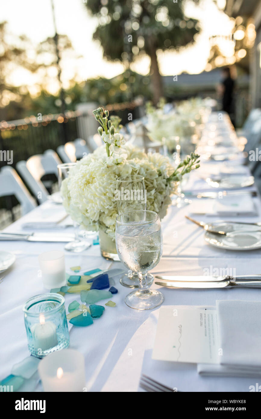 Table set up for outdoor sunset wedding reception Stock Photo - Alamy