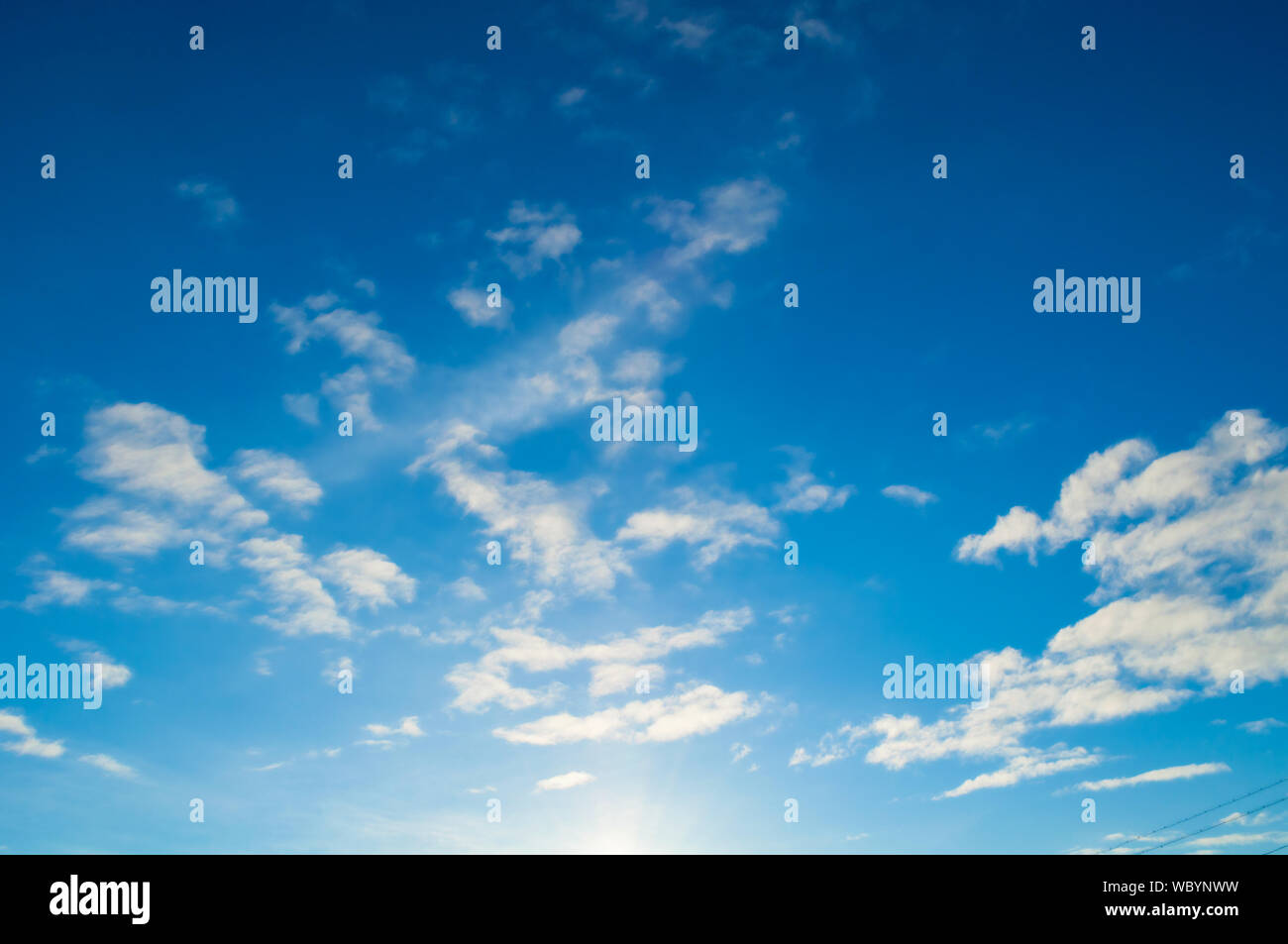 Blue dramatic sky background - picturesque bright clouds lit by ...